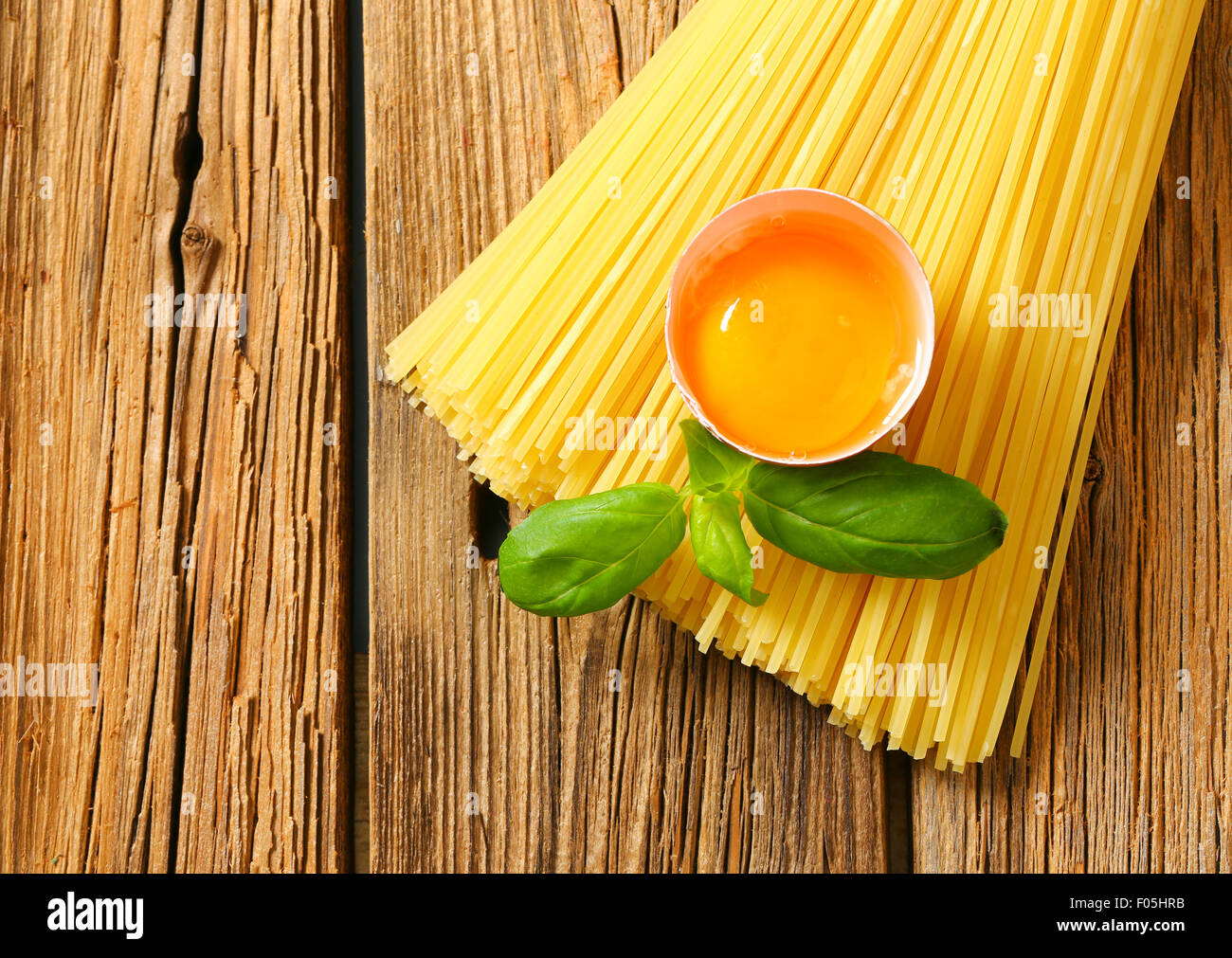 Bundle of spaghetti and raw egg Stock Photo - Alamy