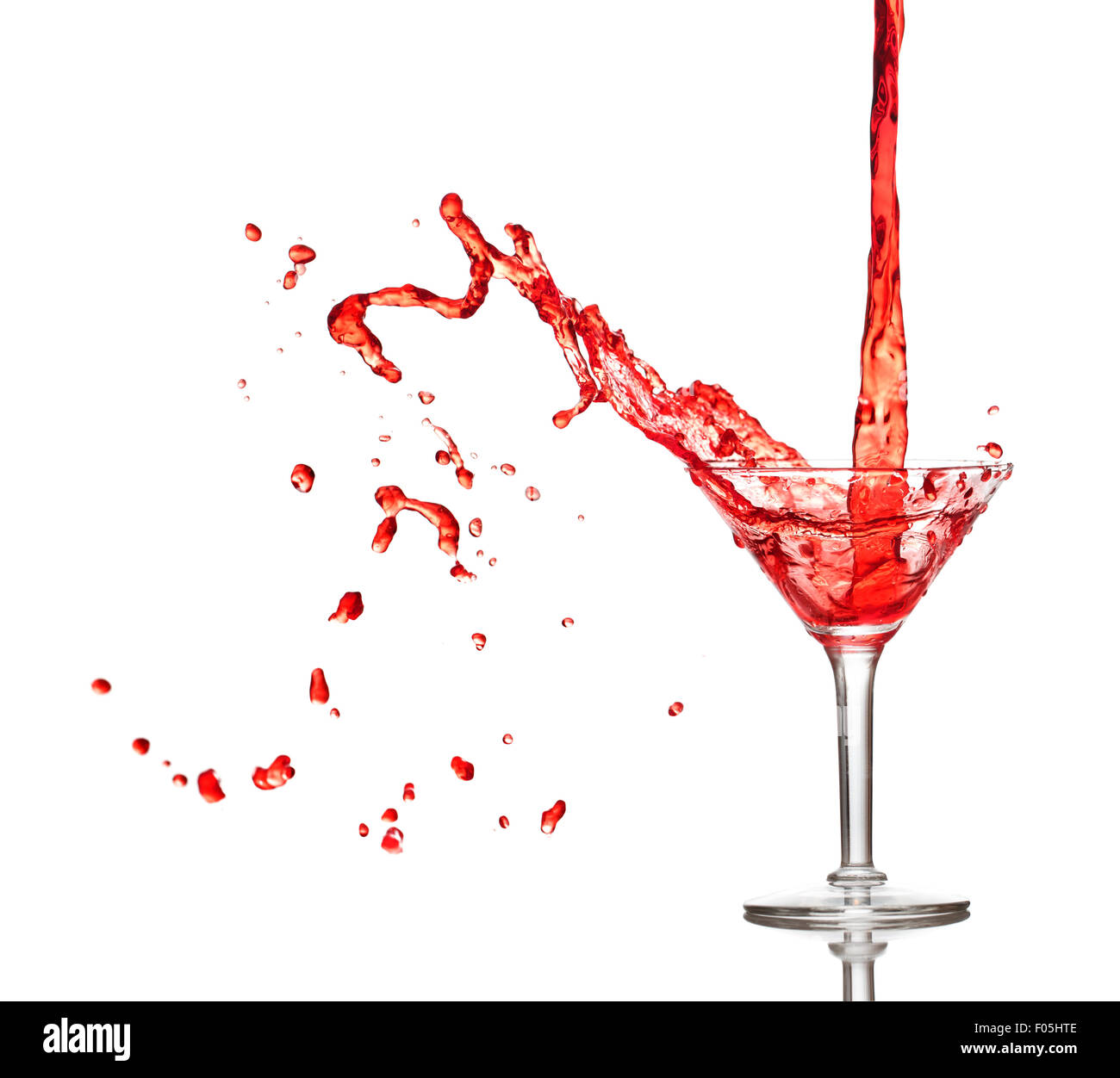 Red cocktail splashing from glass isolated on white background Stock ...