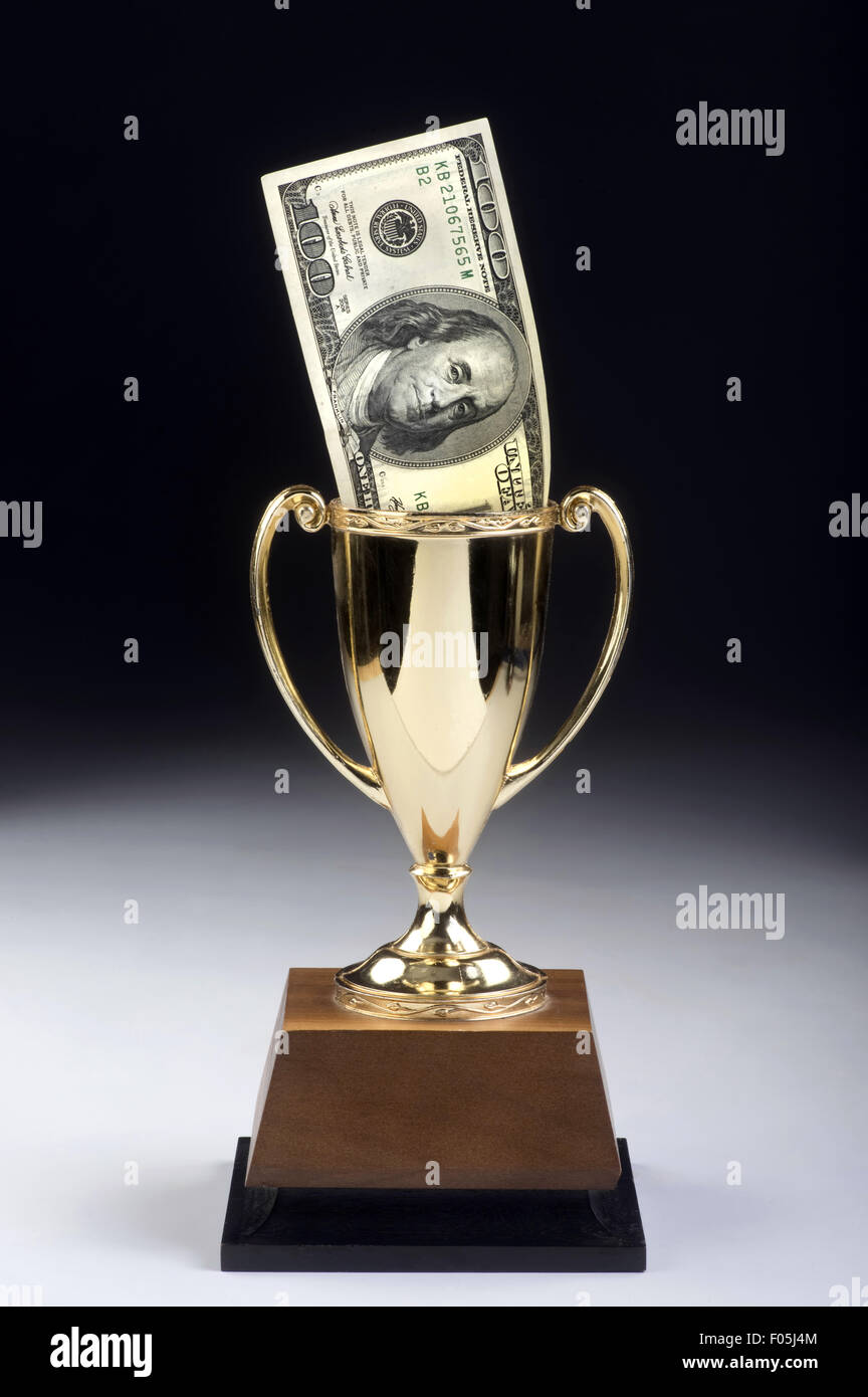 American money winner in a gold trophy Stock Photo - Alamy