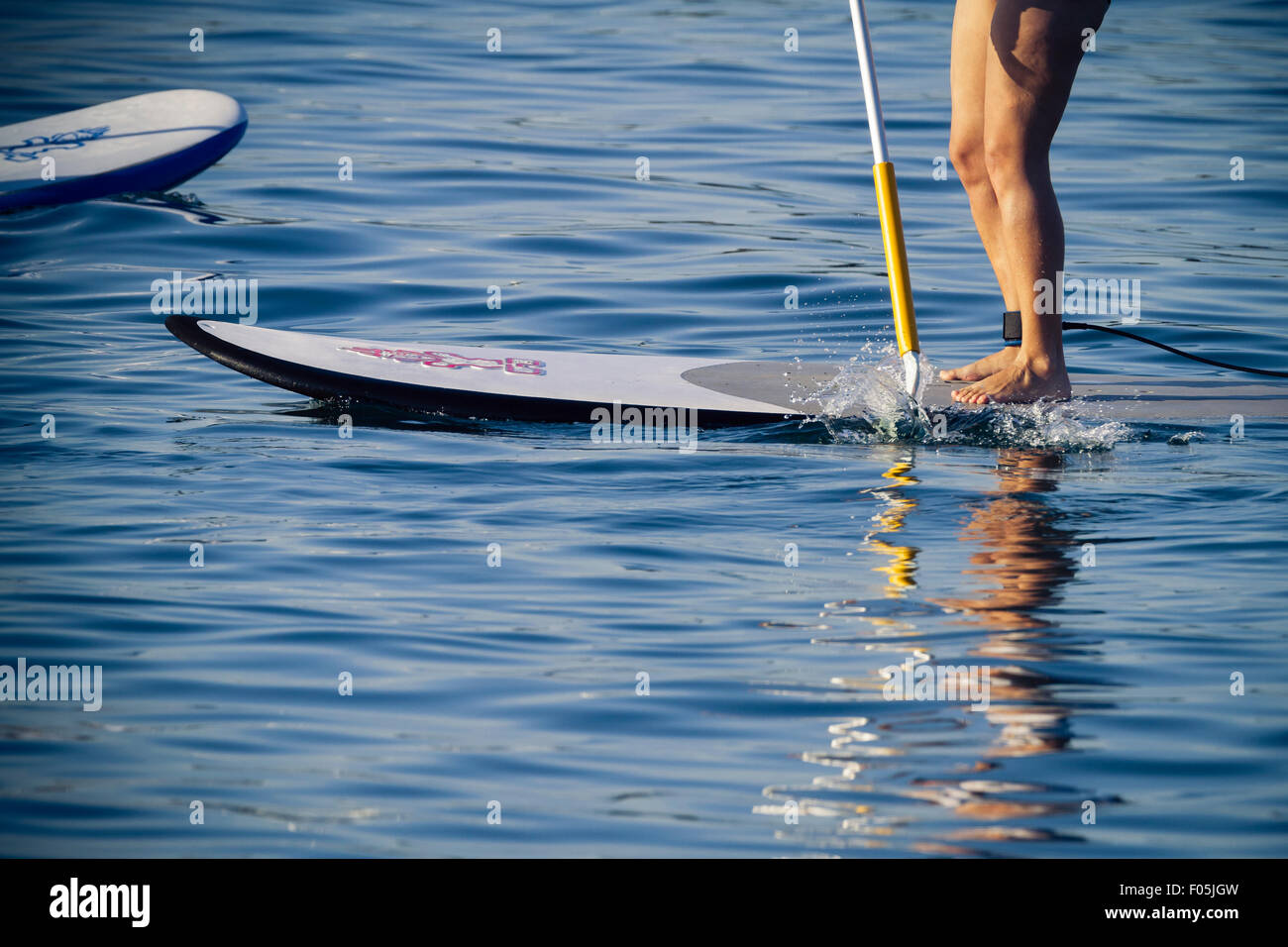 Beatriz Quinta paddling on a stand up paddle board on Oza Beach. A ...