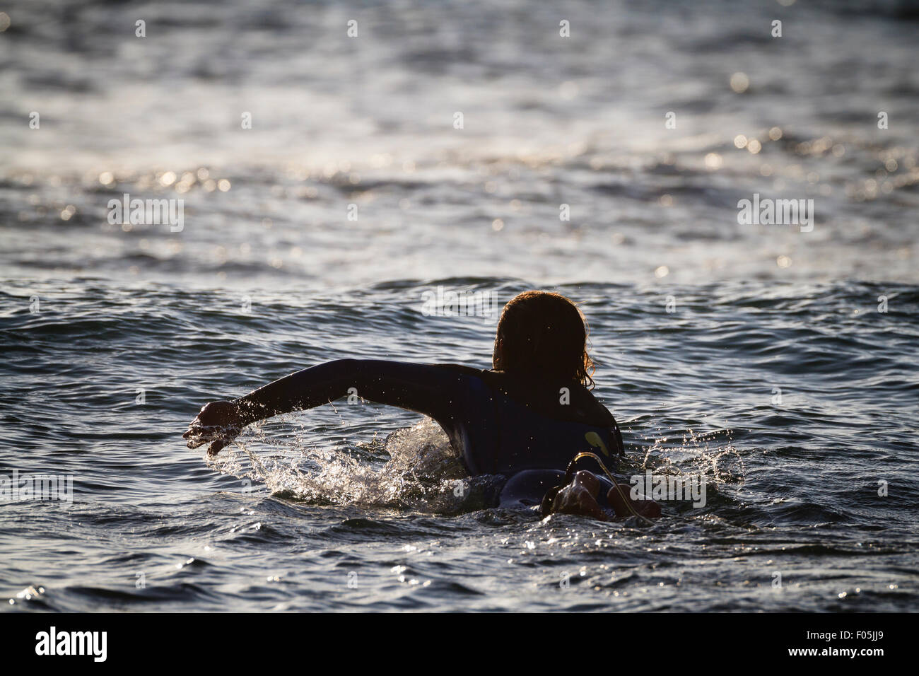 Surfer Pablo Macineira paddling on a surfboard. Orzan Beach. A Coruna ...
