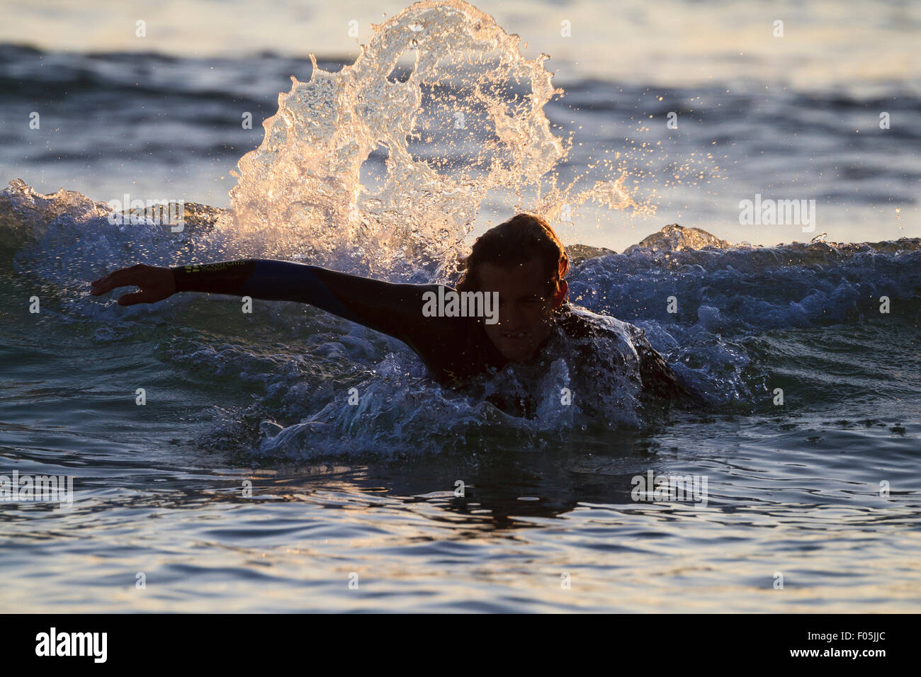Surfer Pablo Macineira paddling on a surfboard. Orzan Beach. A Coruna ...