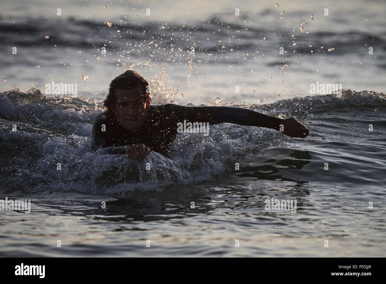 Surfer Pablo Macineira paddling on a surfboard. Orzan Beach. A Coruna ...