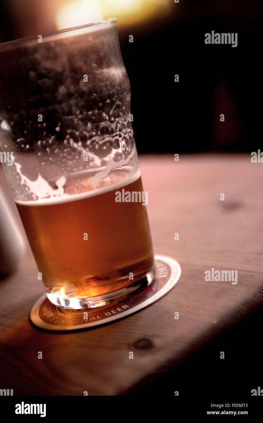 Half empty pint of real ale in pub / pint of beer Stock Photo - Alamy