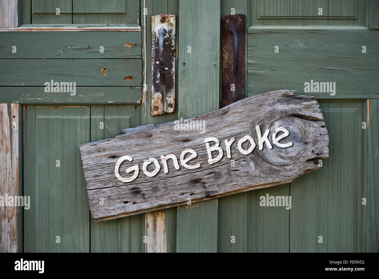 Gone broke sign on old green doors Stock Photo - Alamy