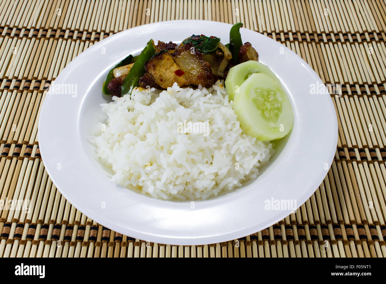 Rice and Stir-fried crispy pork in white dish Stock Photo - Alamy