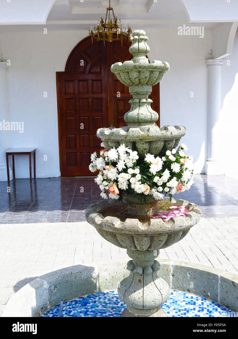 The entrance of a church with a nice fountain right in front of the ...