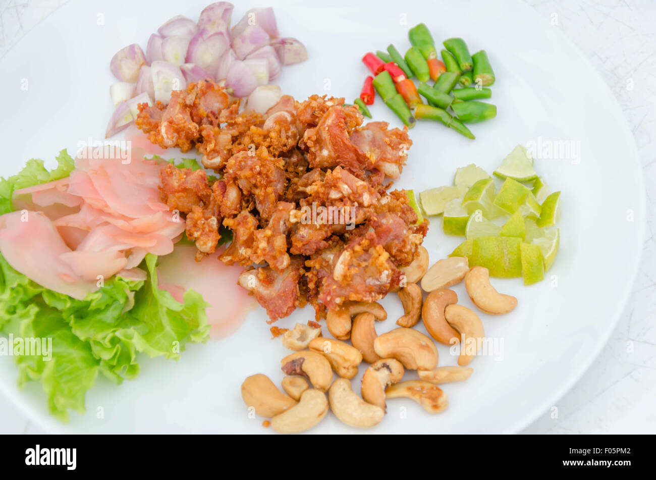 Deep fried sour fermented chicken knees tendon served with vegetables ...