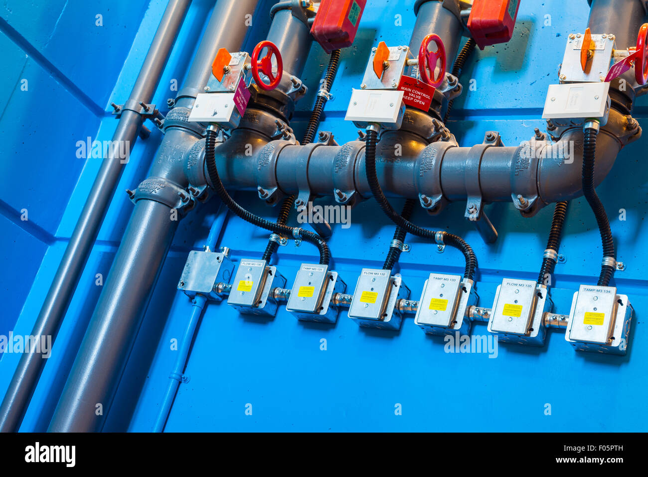 Plumbing system controls mounted on a stairwell wall in a LEED ...