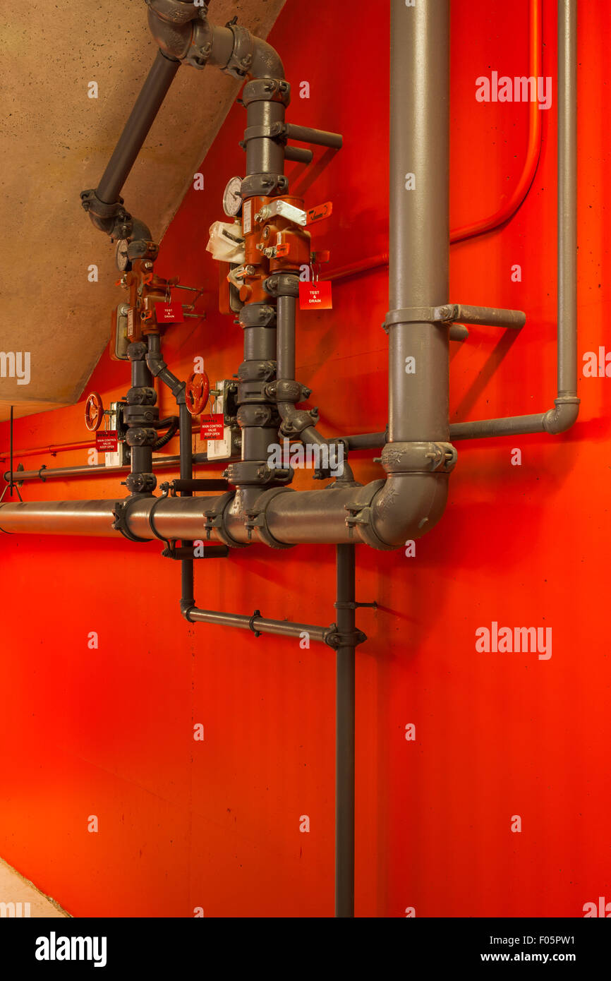 Plumbing system controls mounted on a stairwell wall in a LEED ...