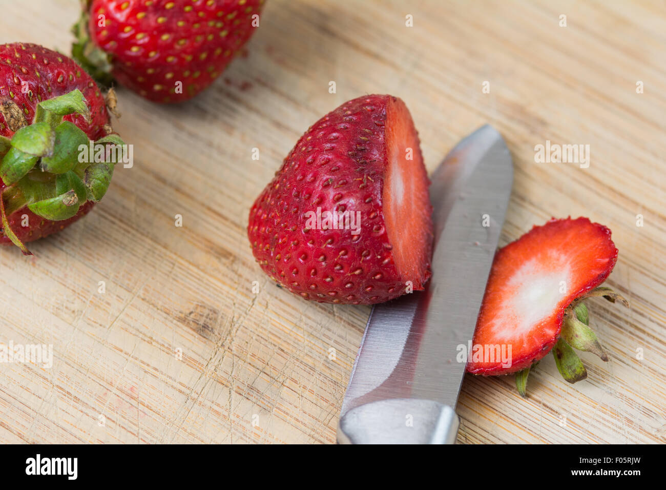 Knife cutting a strawberry Stock Photo - Alamy