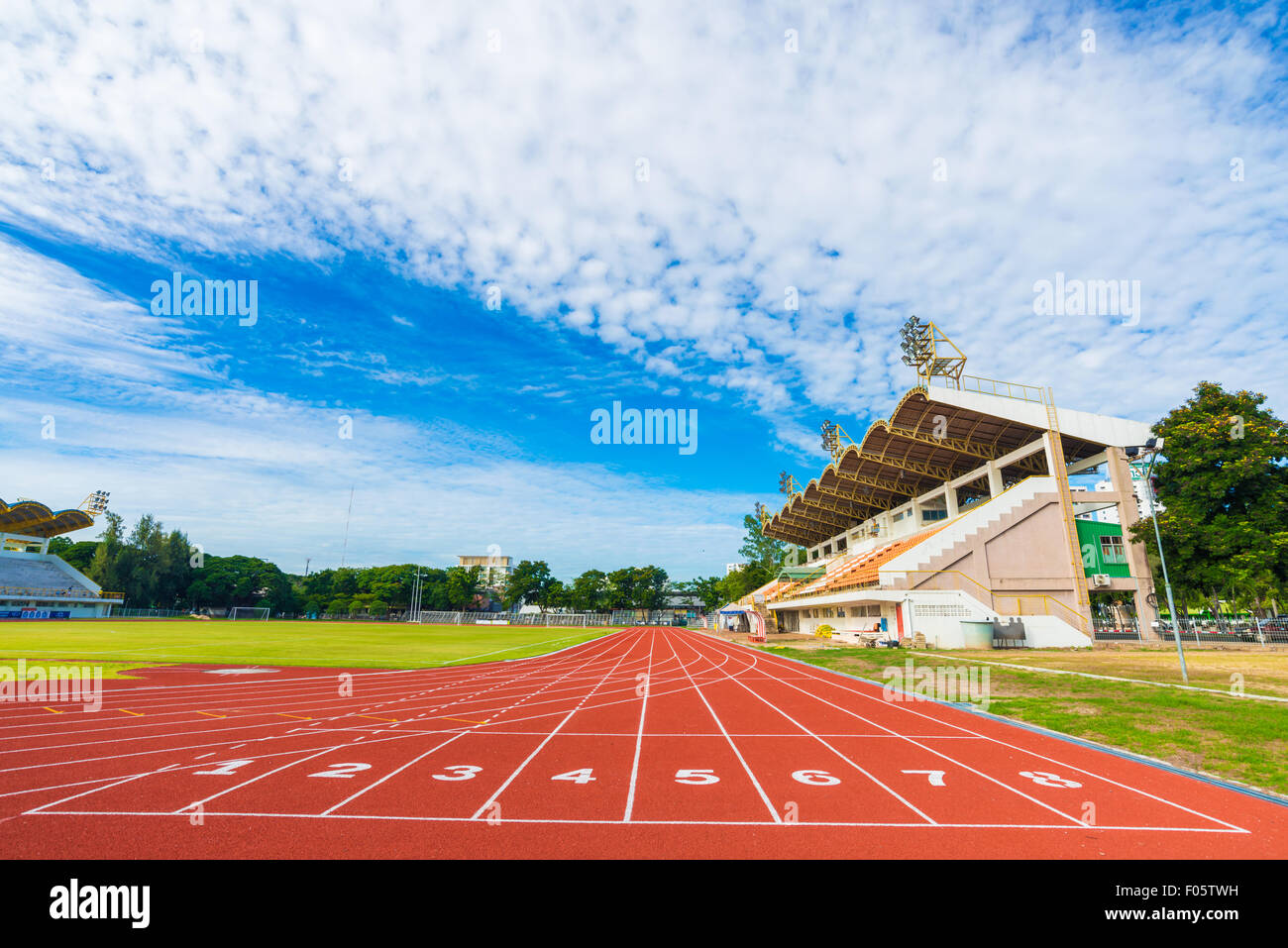 Running track with numbers over blue sky and clouds Stock Photo - Alamy