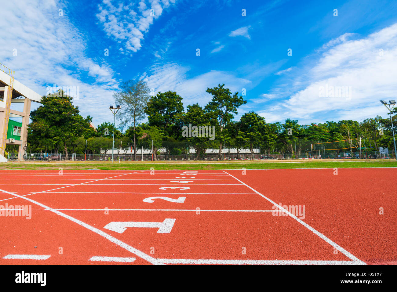 Running track with numbers over blue sky and clouds Stock Photo - Alamy