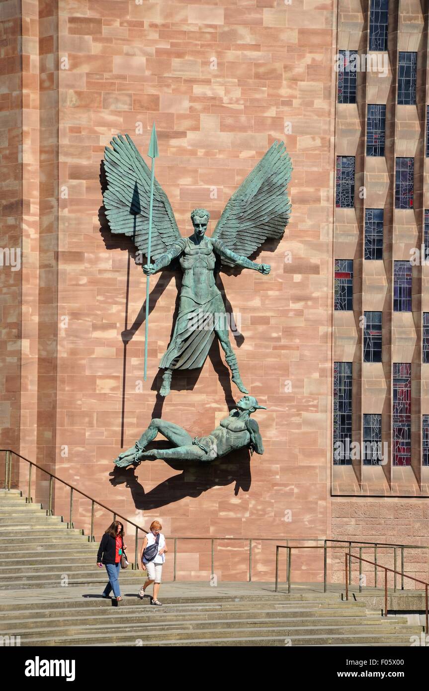 Statue of St Michael holding a spear over the devil (Michael and the ...