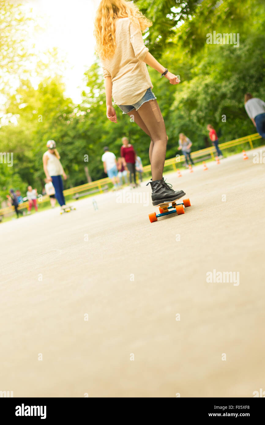Teenage girl urban long board riding Stock Photo - Alamy