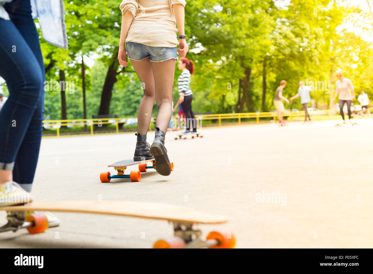 Teenage girl urban long board riding Stock Photo - Alamy