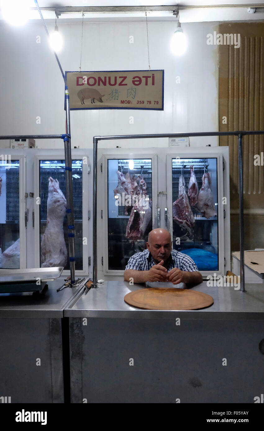 A Muslim vendor selling pork meat in Taza Bazaar market in the city of ...