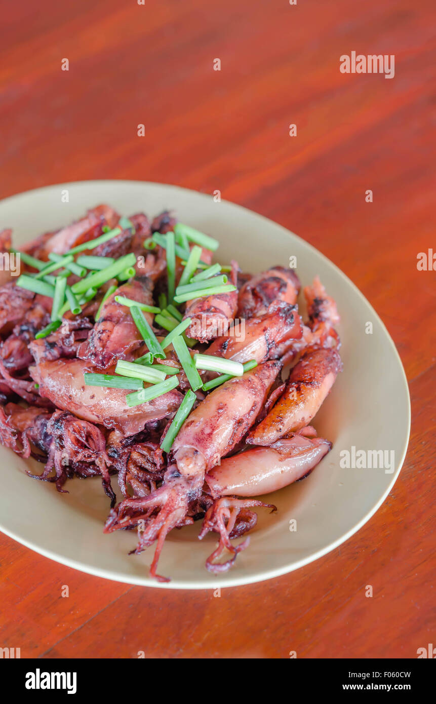 plate of sauteed small squid fried with garlic and sauce Stock Photo ...