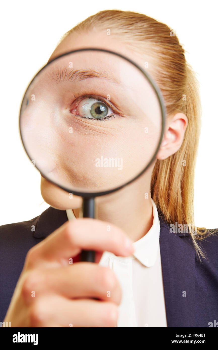 Business woman looking suspicious with her eye through a magnifying ...
