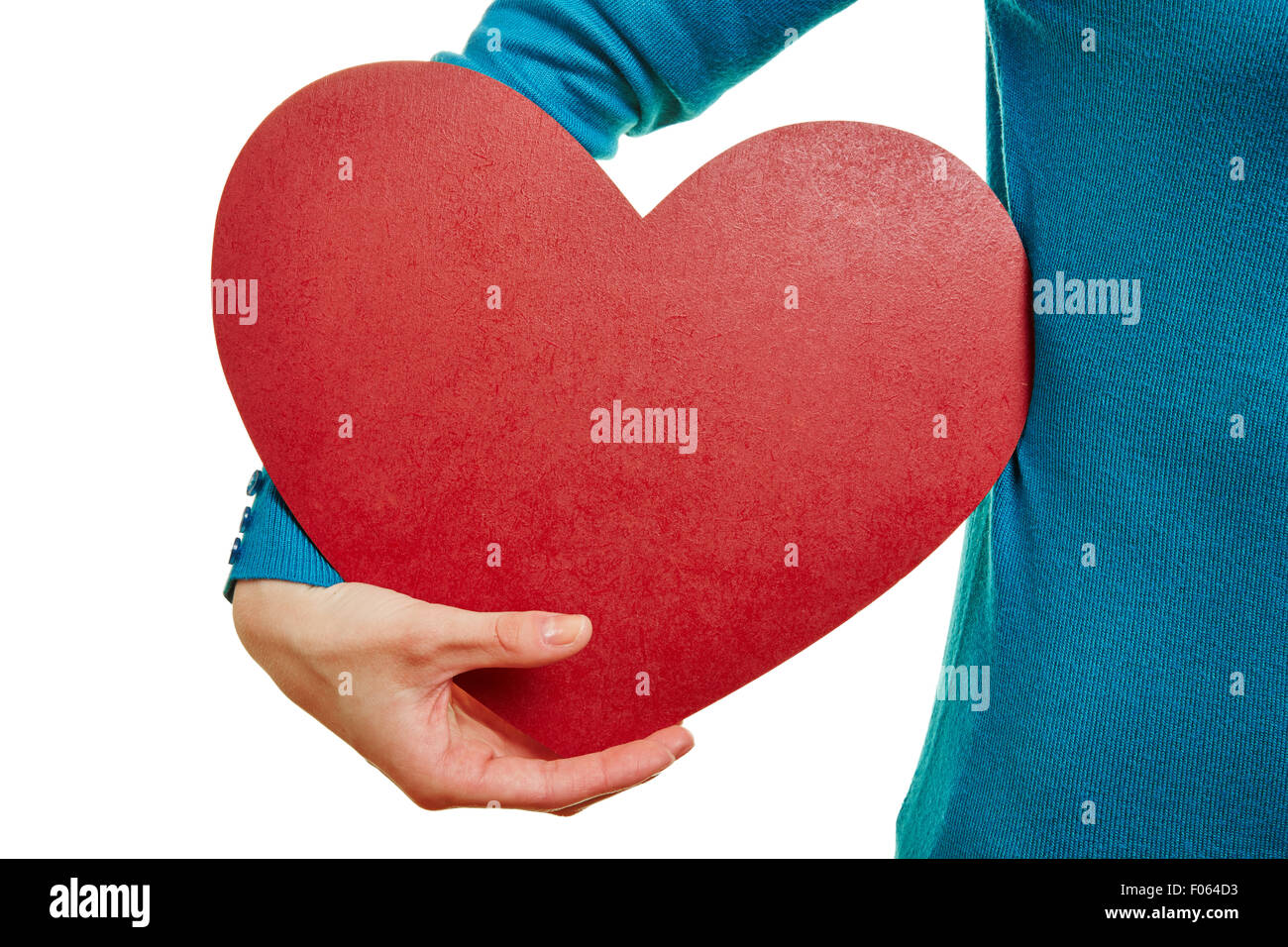 Hand carrying a big red heart on the arm Stock Photo - Alamy