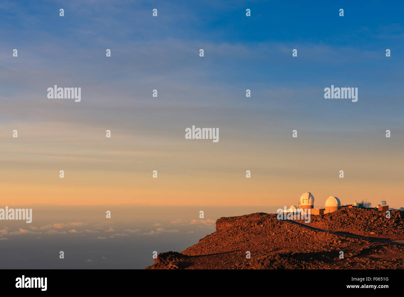 Sunset above the clouds over 3000 meters at the Haleakala Volcano, Maui ...
