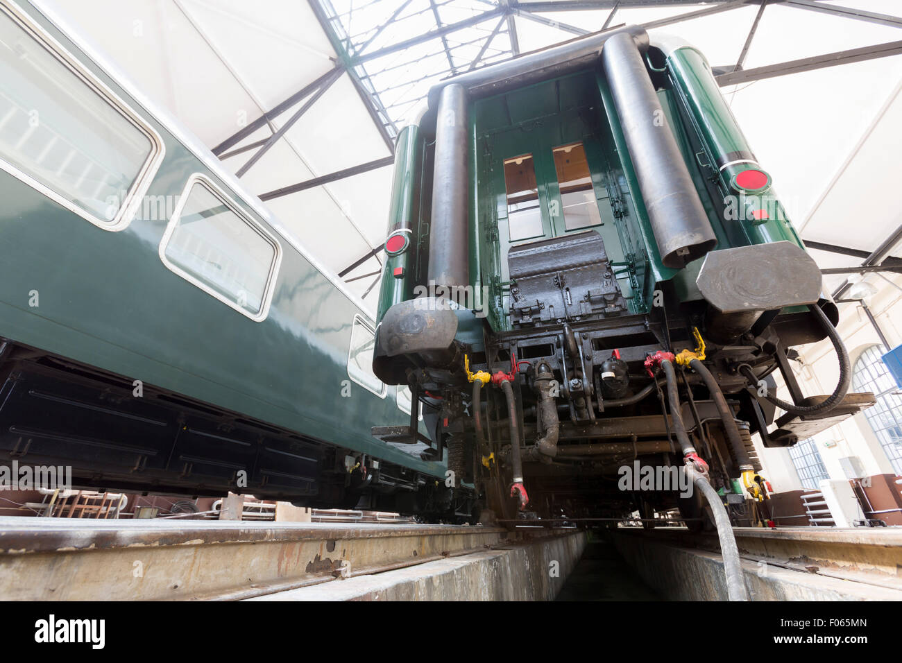Old authentic green passenger trains in a depot for renovation before ...