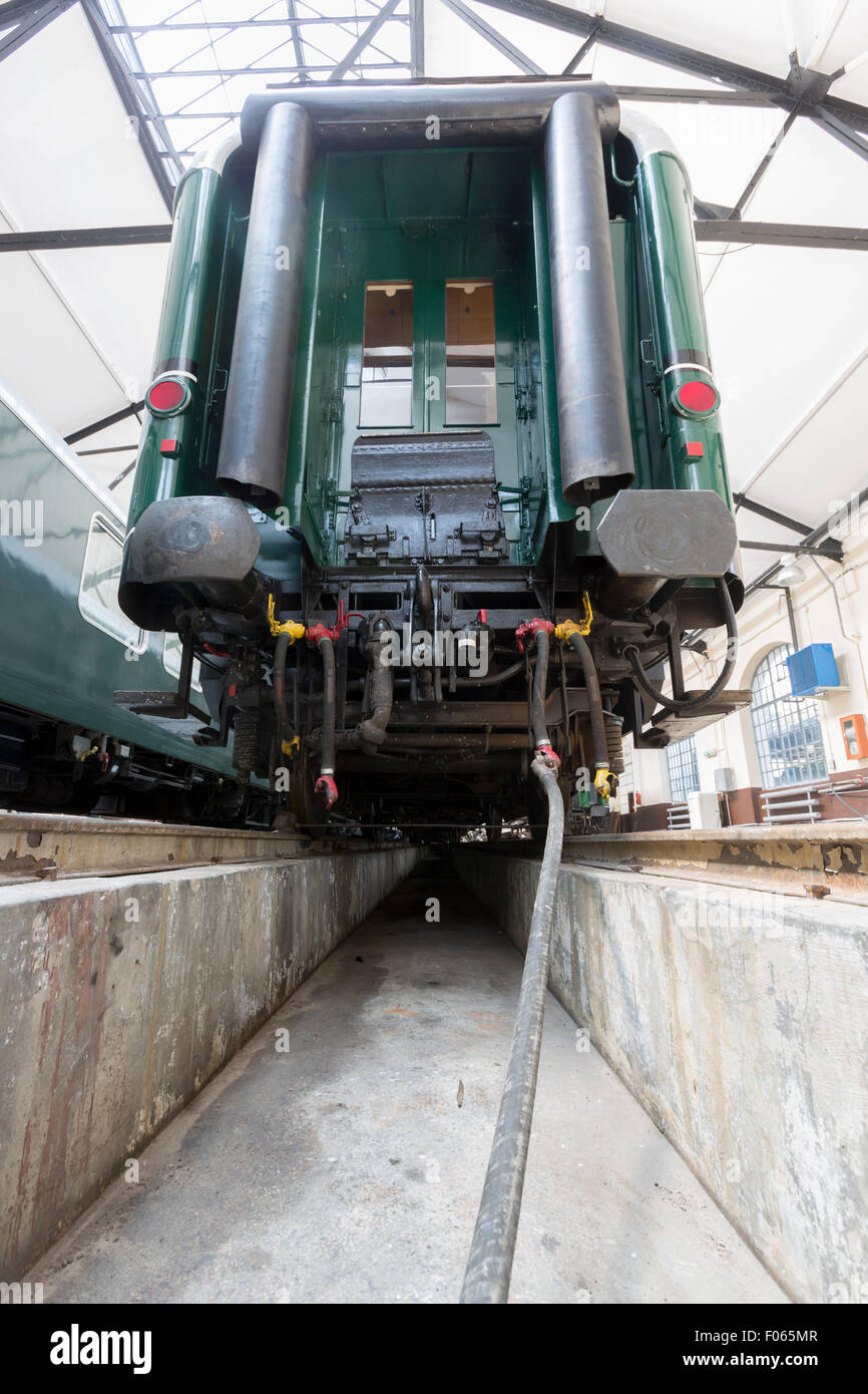 Old authentic green passenger trains in a depot for renovation before ...