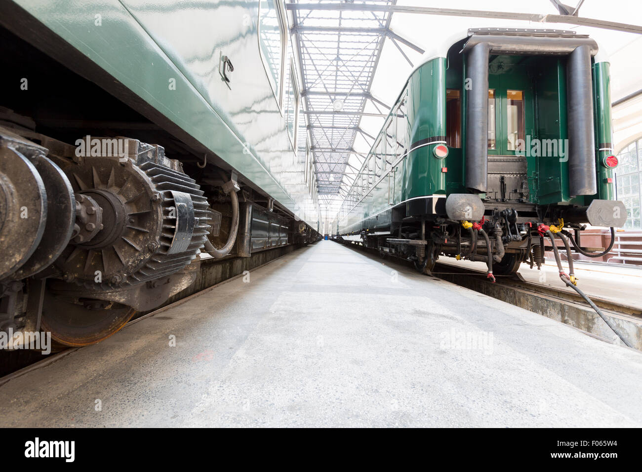 Old authentic green passenger trains in a depot for renovation before ...
