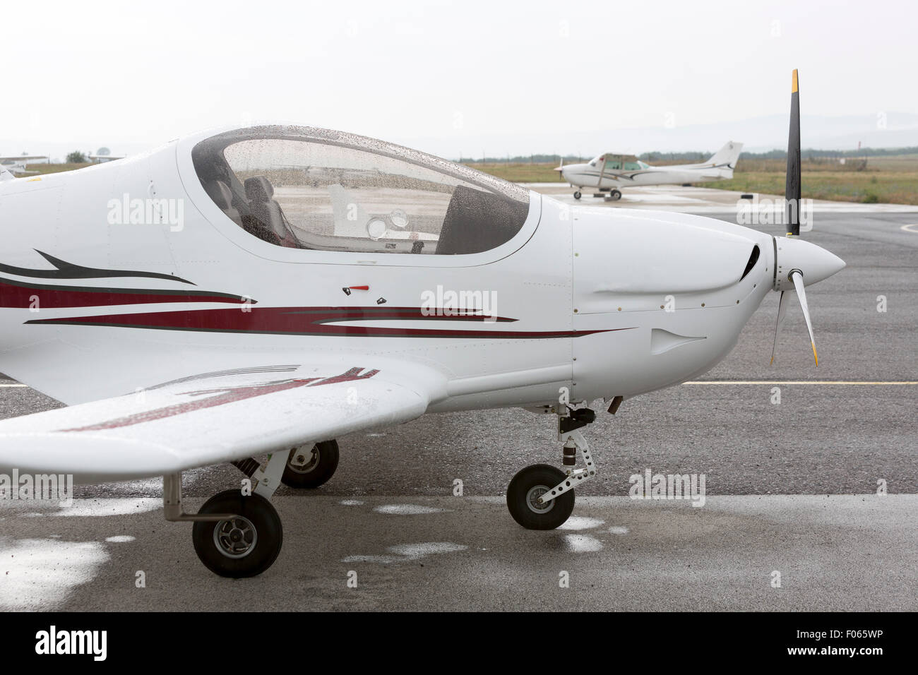 Small two-seated propeller airplane on the ground at the airport Stock ...