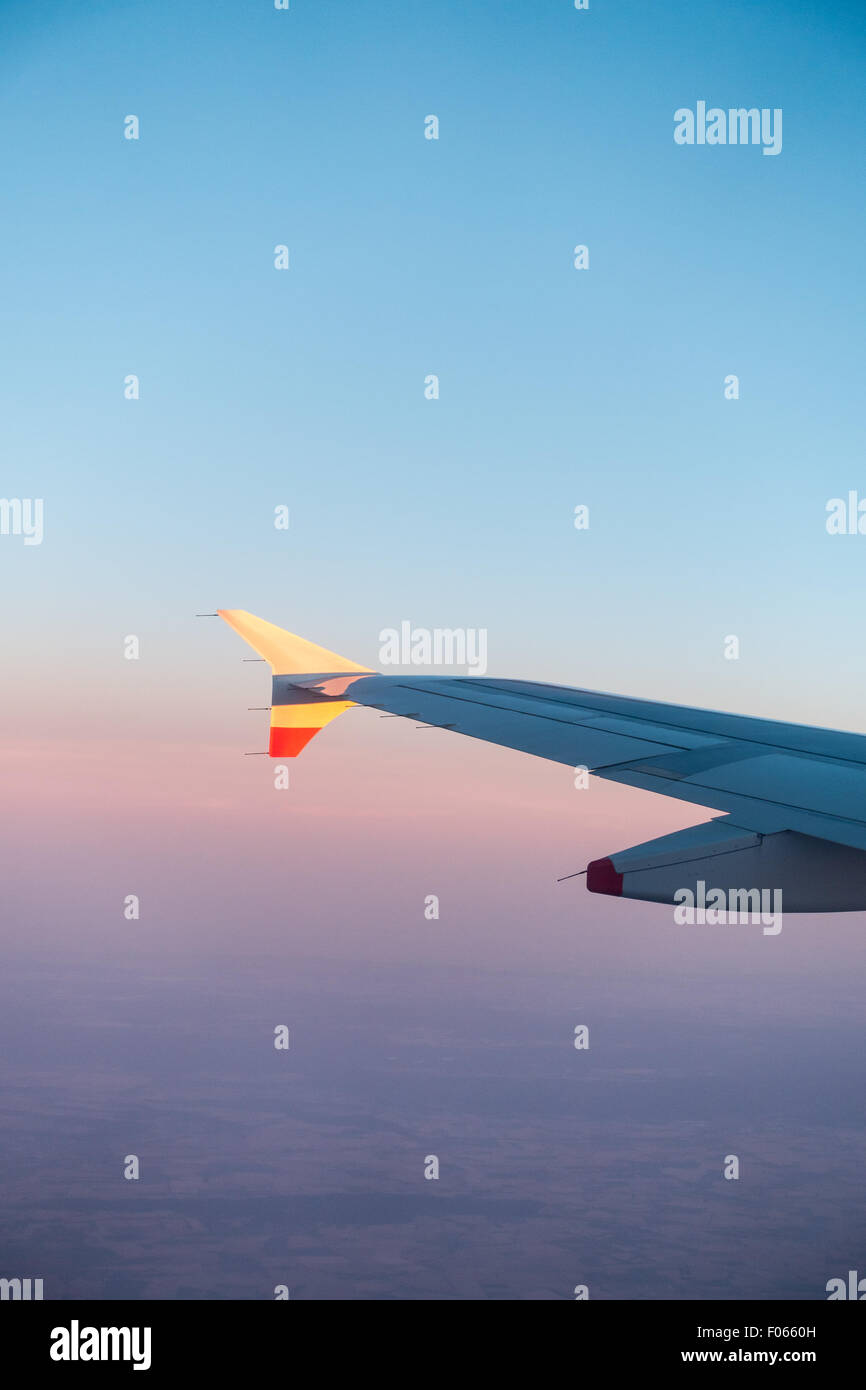 View out an airplane window past its left wing on a beautiful summer ...