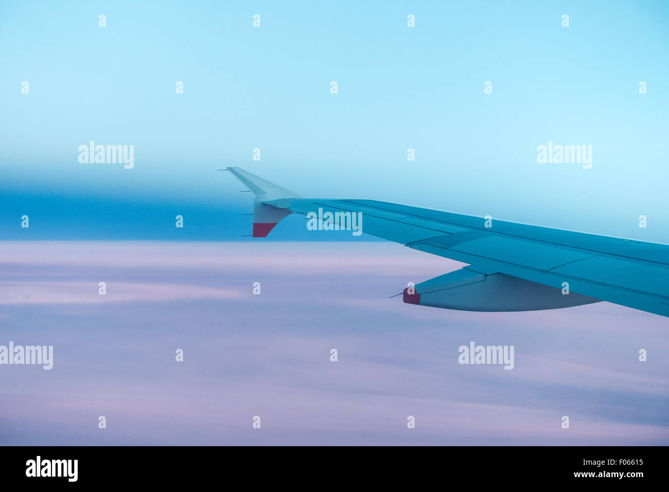 View out an airplane window past its left wing on a beautiful summer ...