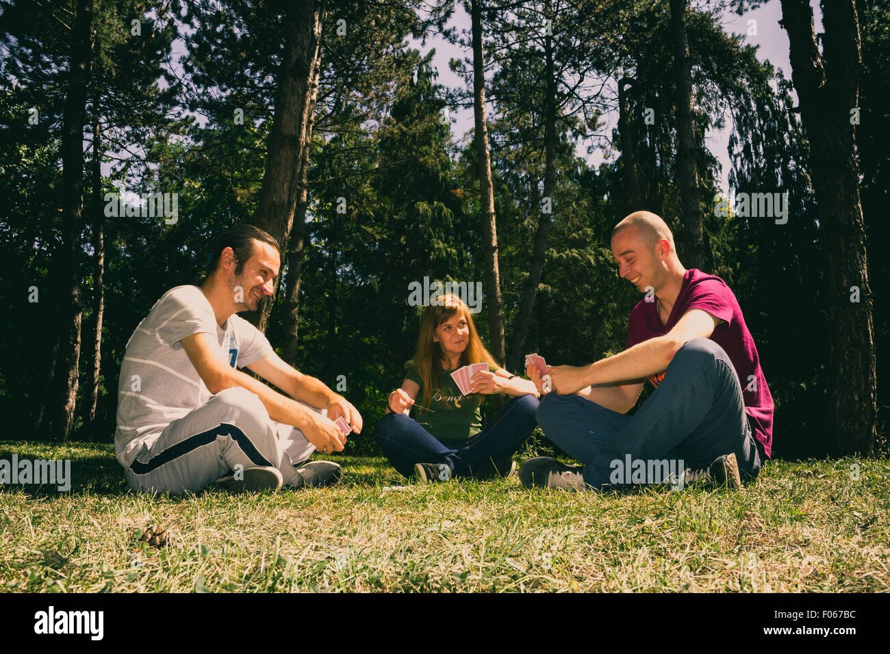 Three friends sitting park hi-res stock photography and images - Alamy