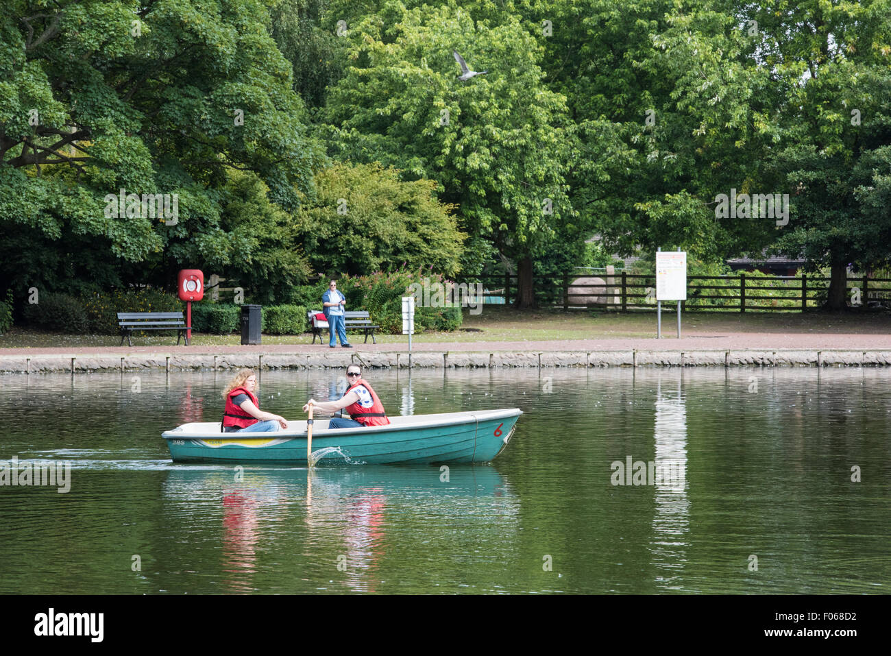 Two girls rowing a boat on the pond at the West Park in Wolverhampton ...