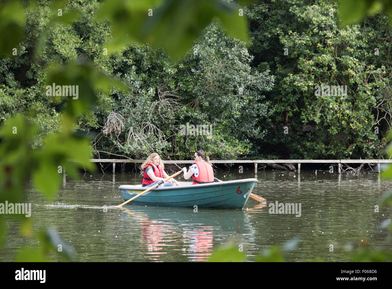 Two girls rowing boat in hi-res stock photography and images - Alamy