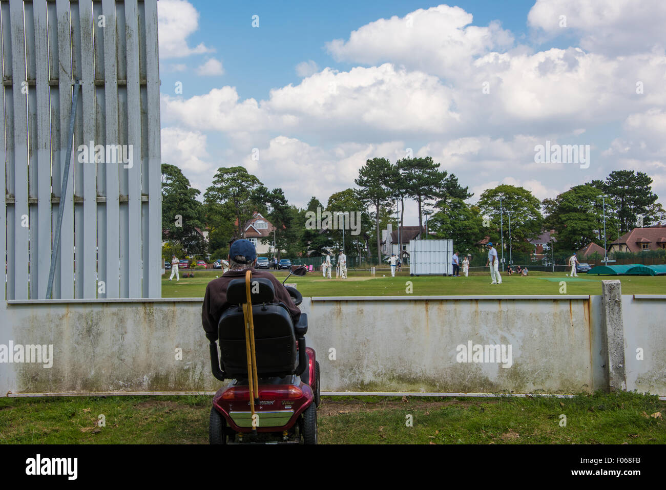 An old man on a mobility scooter watching a Cricket match at ...