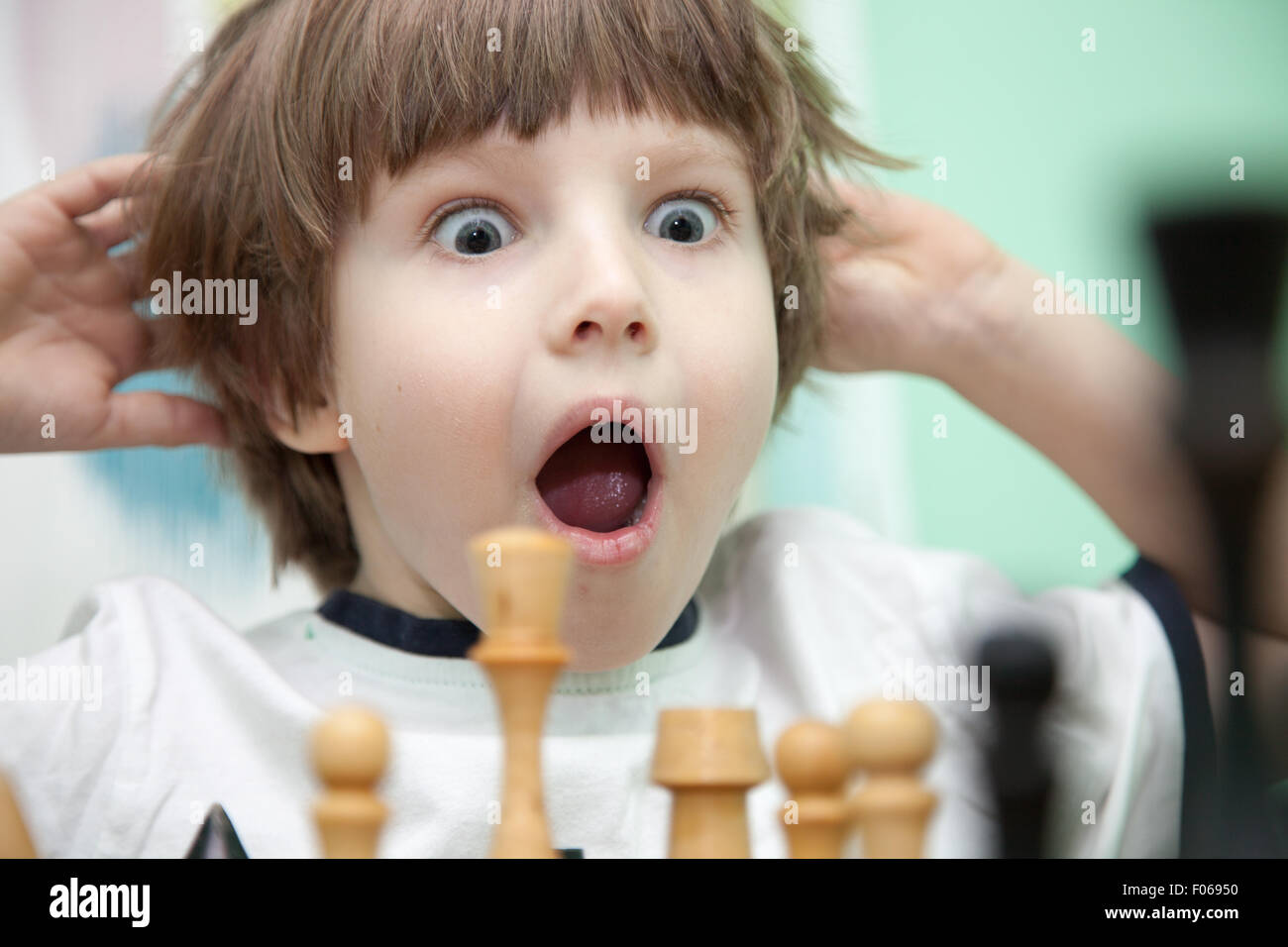 Portrait of a little boy playing chess Stock Photo - Alamy