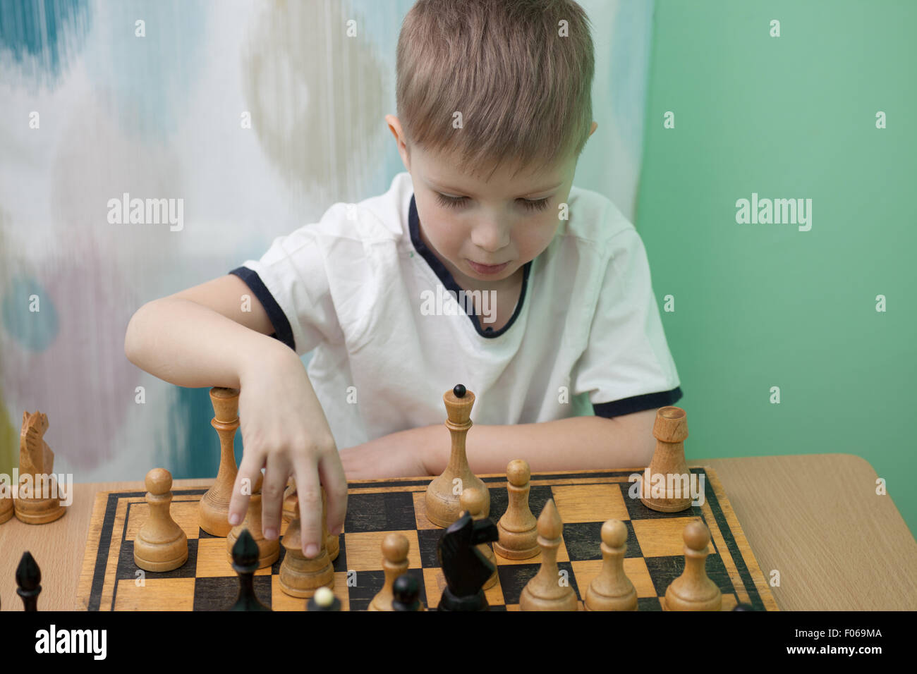 Portrait of a little boy playing chess Stock Photo - Alamy