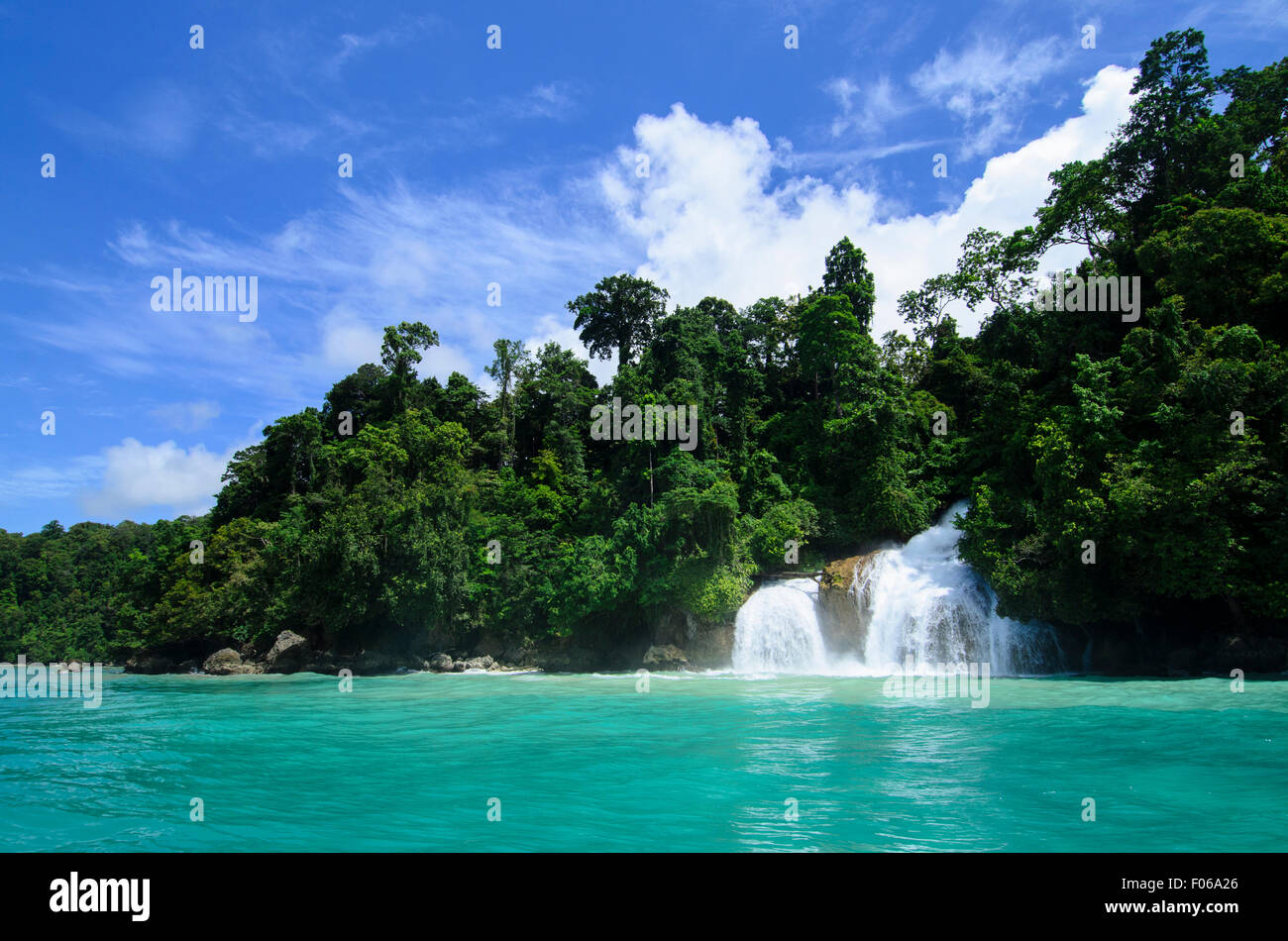 A waterfall plummets into the ocean, Mommon, Banda Sea, West Papua ...