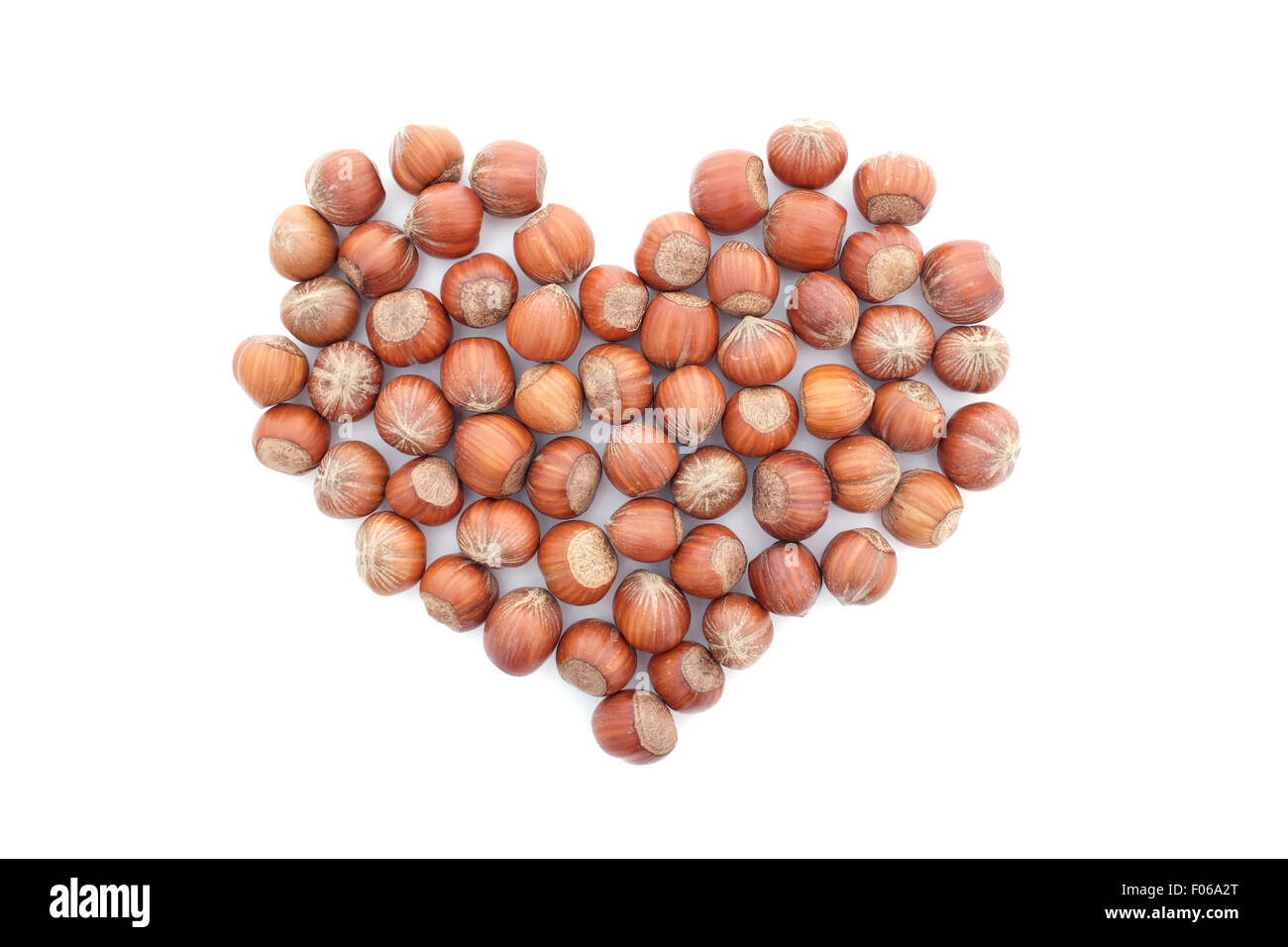 Hazelnuts in a heart shape, isolated on a white background Stock Photo ...