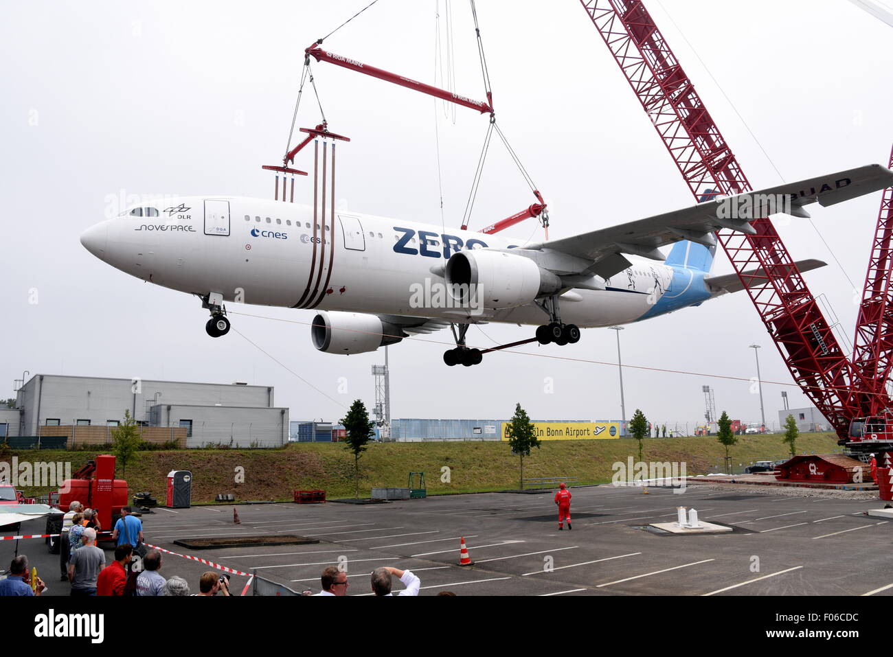 An Airbus A 300 is lifted onto a parking area using a 60-metre-high ...