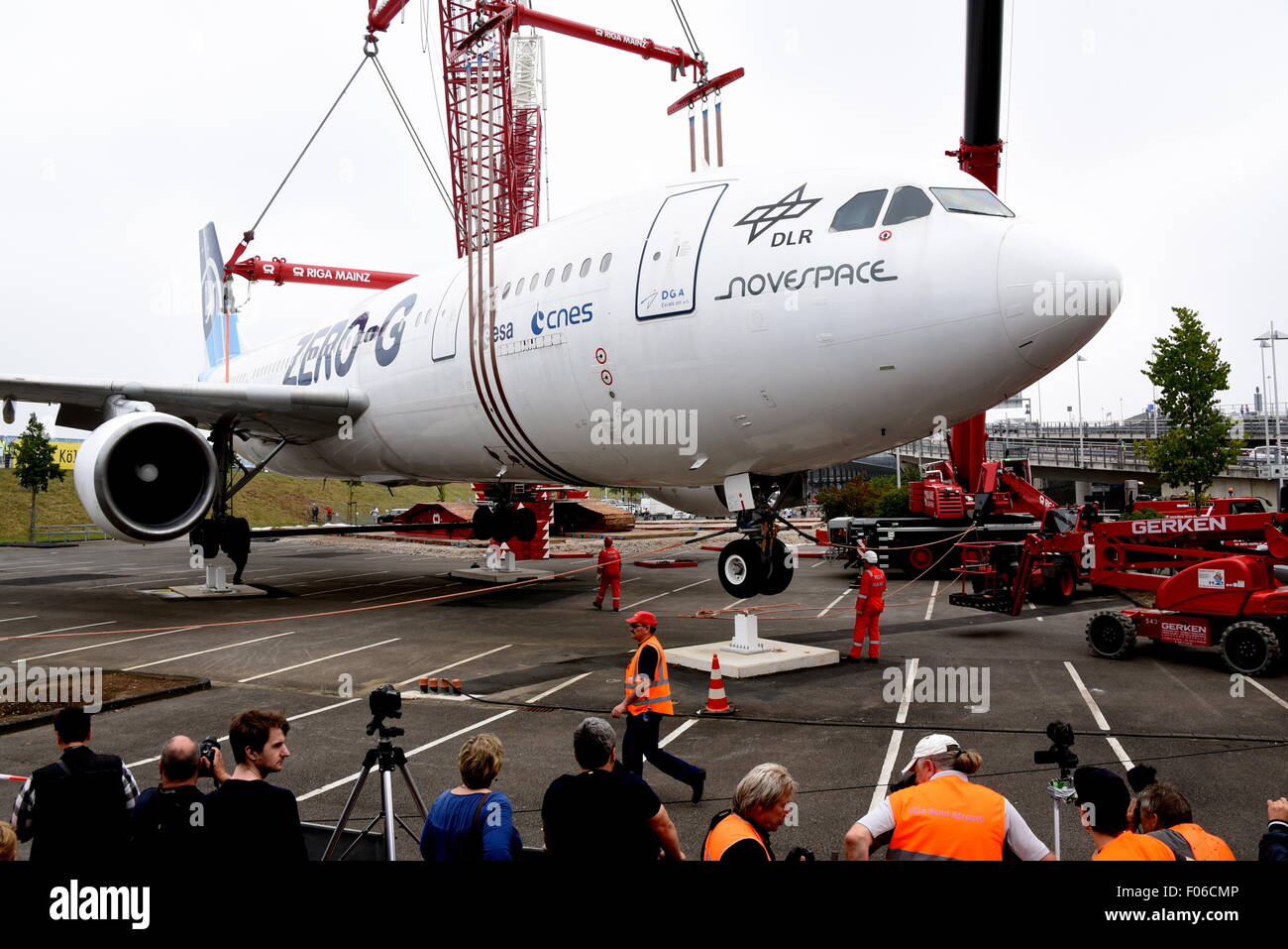 An Airbus plane type A 300 is lifted by a60-metre-high crane onto a ...