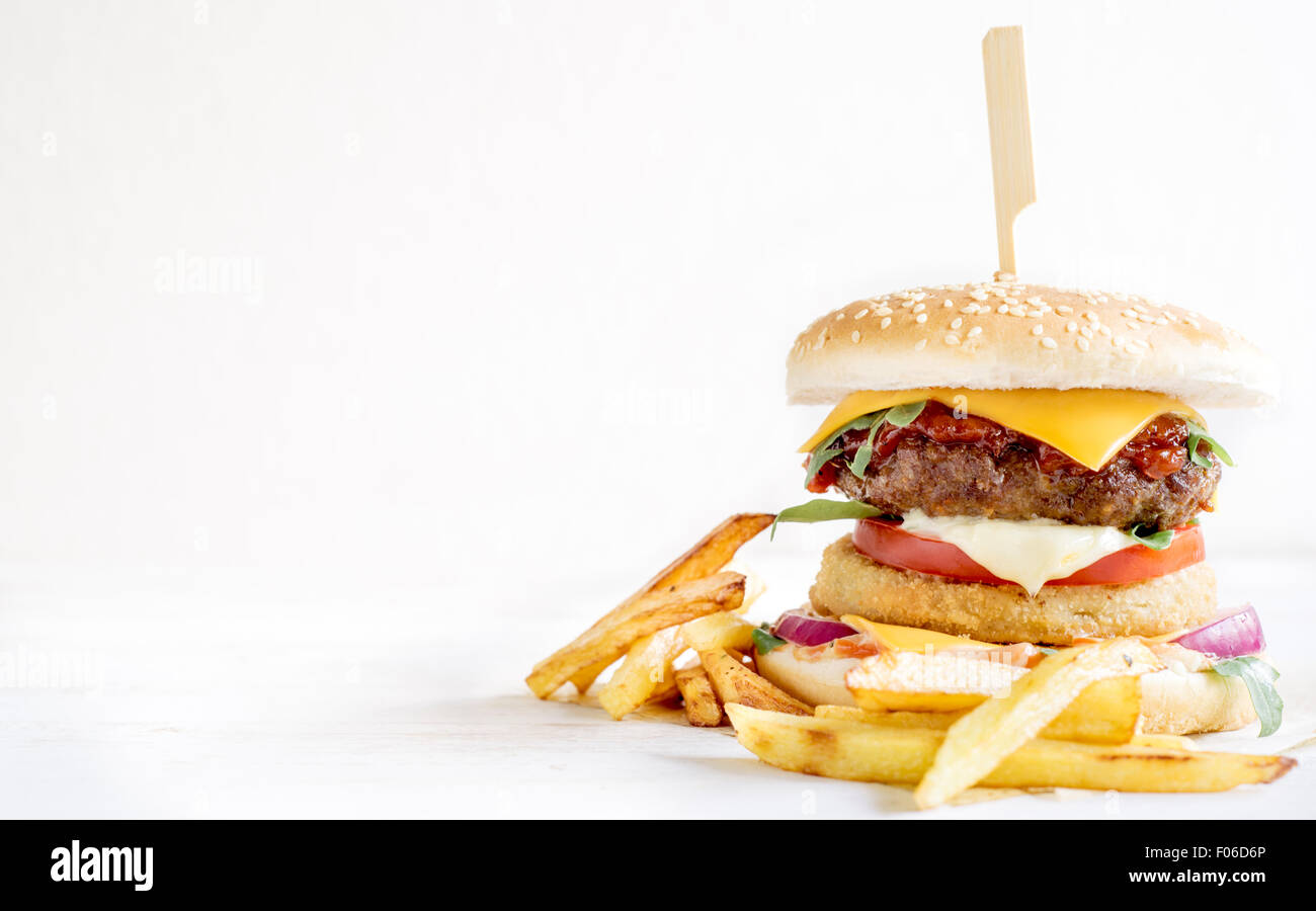 Beef and fish burger with french fries,served on white background ...