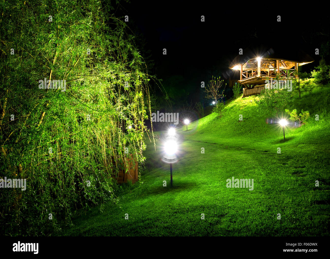 Wooden arbour and green osier at night Stock Photo - Alamy