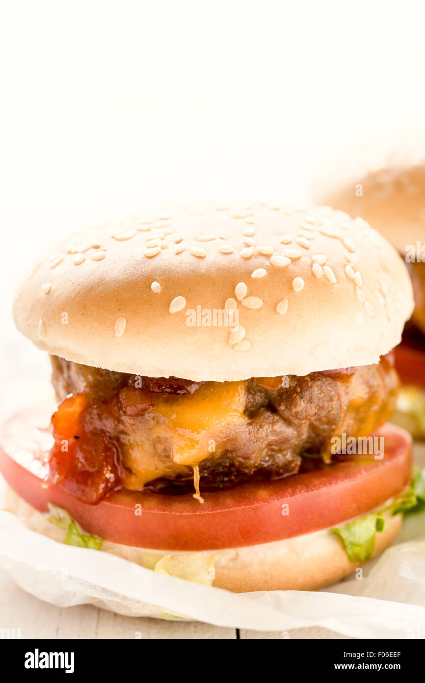 Close up to mini beef burgers with melted cheddar cheese and bbq sauce ...