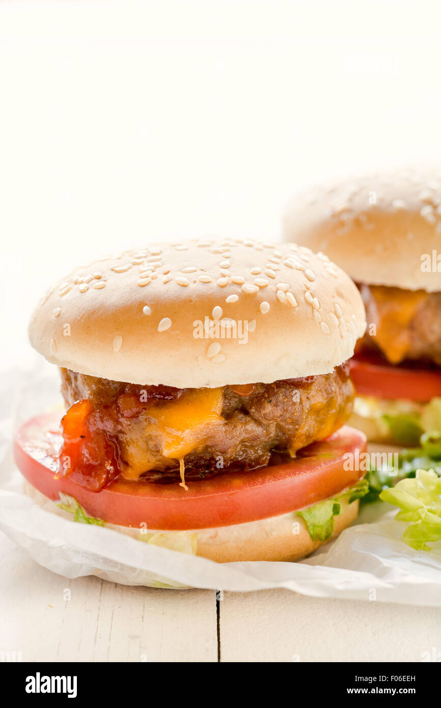 Mini beef burgers with melted cheddar cheese and bbq sauce on wooden ...
