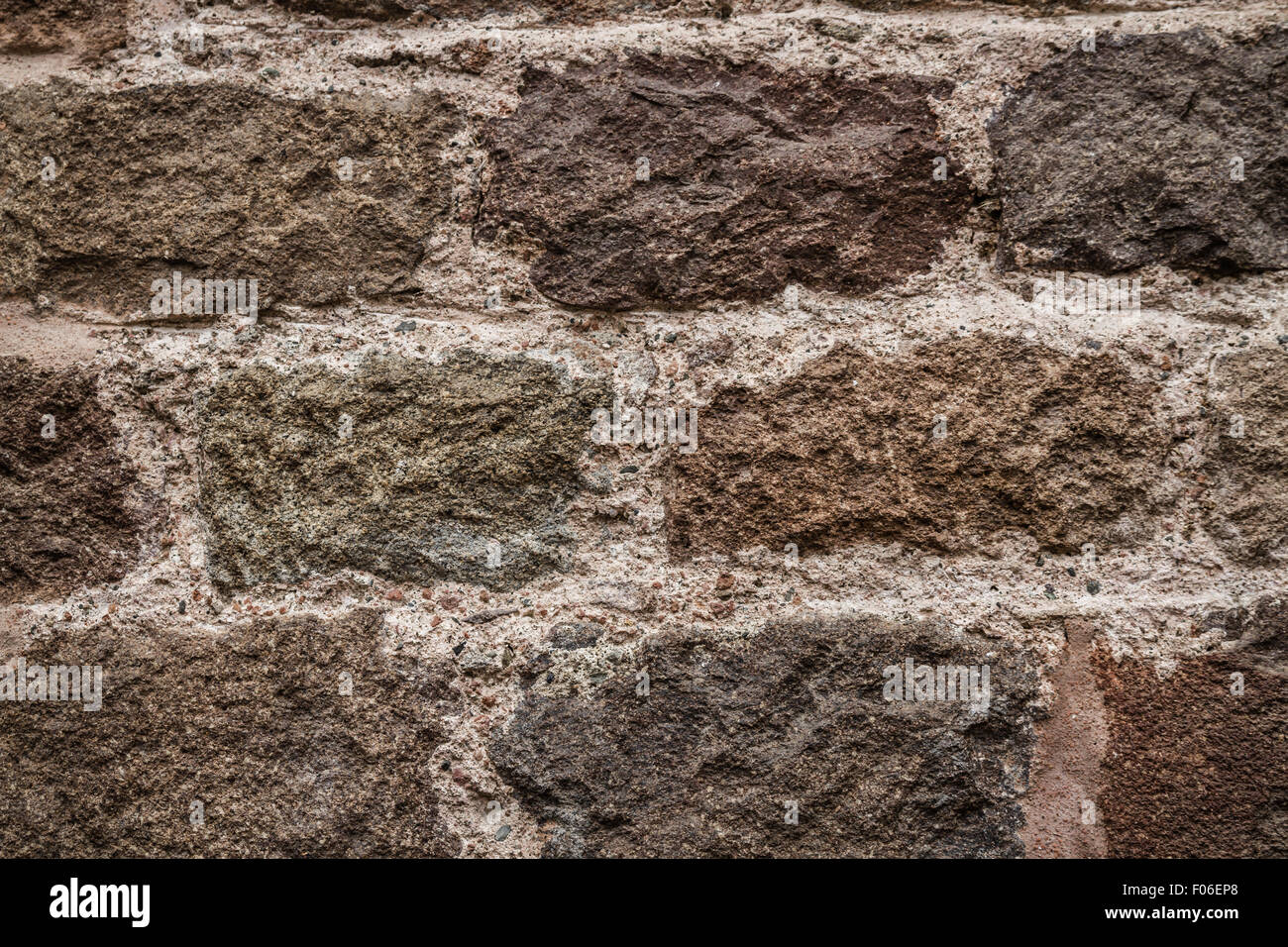 View of a natural stone wall built with clay mortar Stock Photo - Alamy