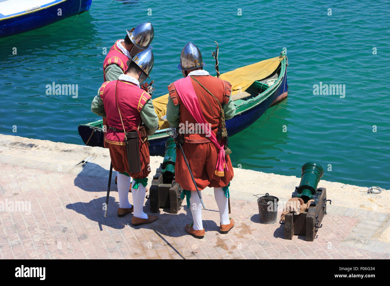 3 Maltese medieval soldiers preparing to fire their cannons in Saint ...