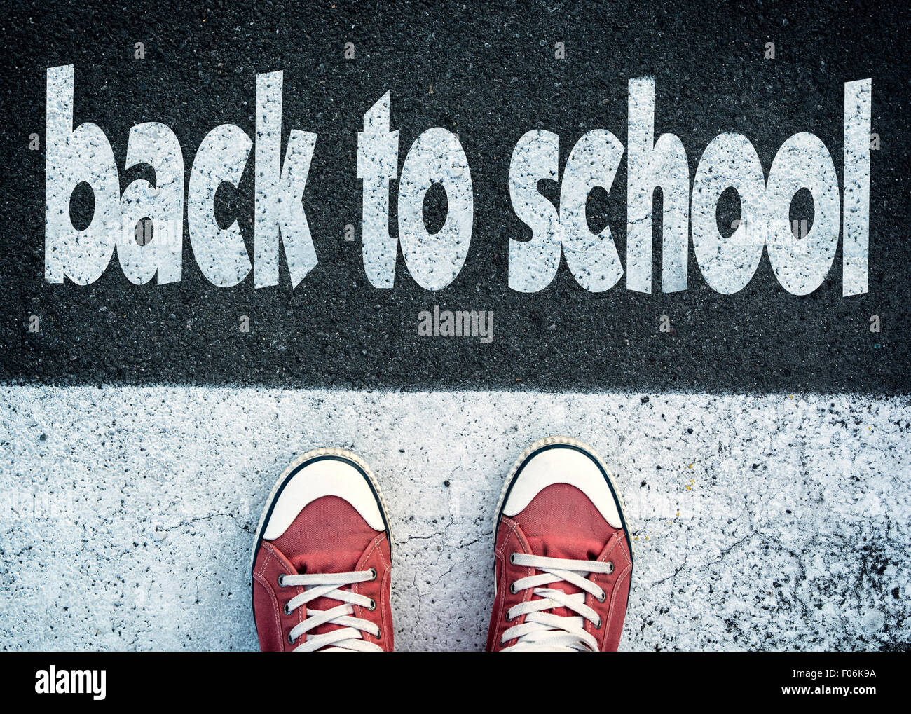 Student standing above the sign back to school Stock Photo - Alamy