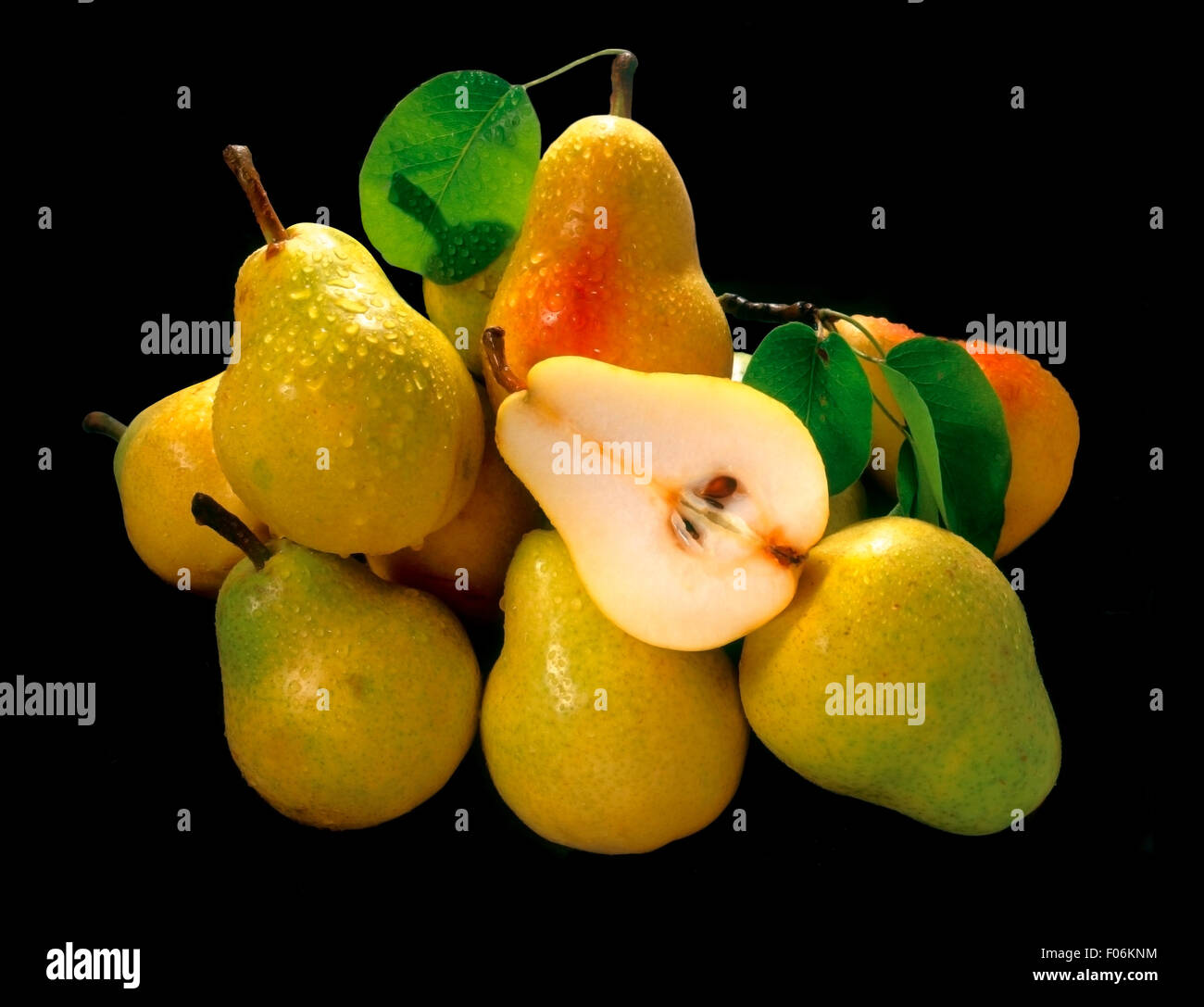 Pears bunched together on black background Stock Photo - Alamy
