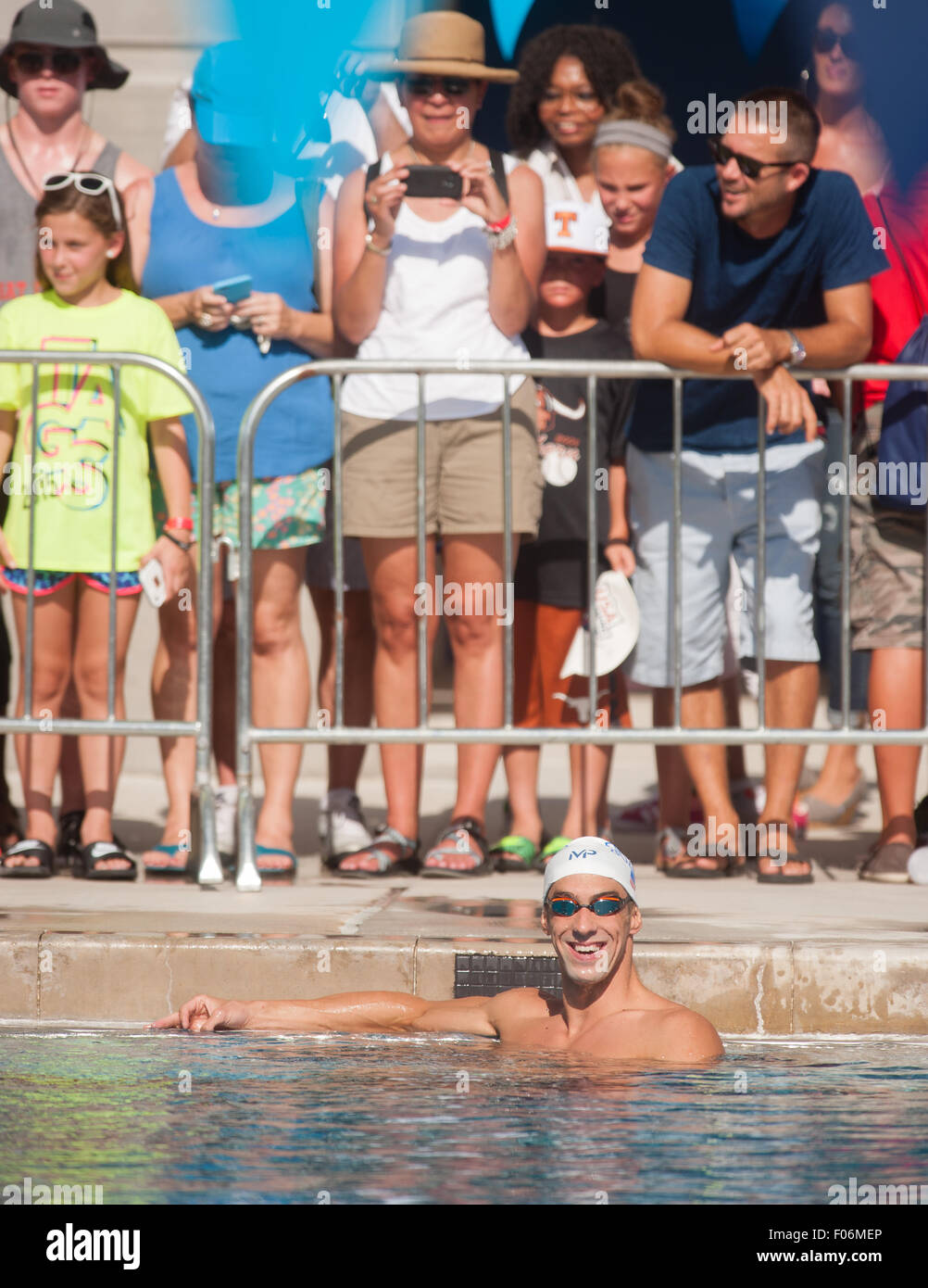 Michael Phelps is watched by fans as he warms up during the Phillips 66 ...
